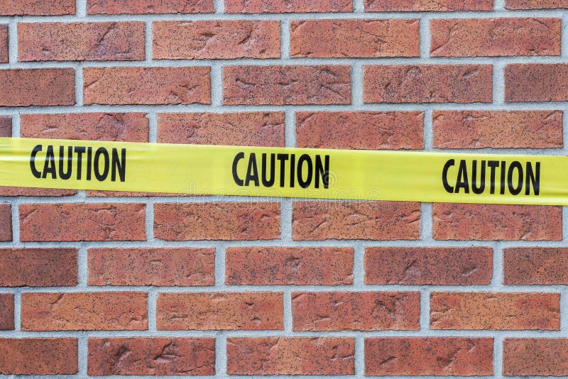 Caution Yellow Tape Against Brick Wall. Stock Image - Image of ...
