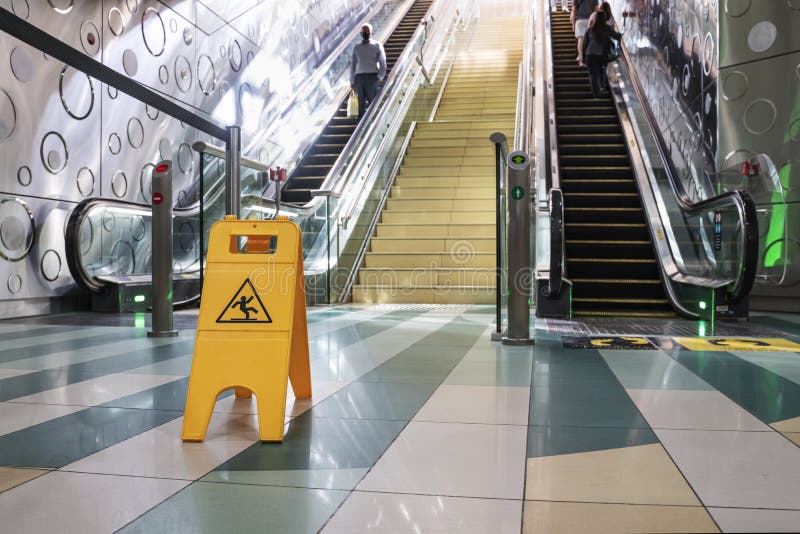 Caution. Yellow Wet Floor Sign in Front of the Escalator Stock Image ...
