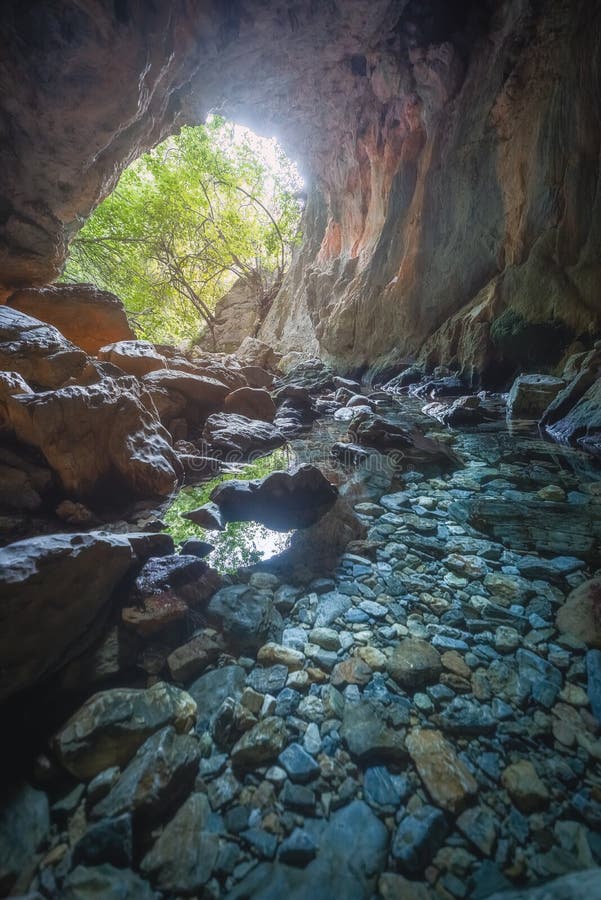 Cave with Blue Water and Trees Outside Stock Photo - Image of beneath ...