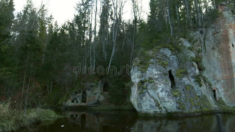 Cliffs with Man-Made Caves on the Riverbank Stock Video - Video of ...