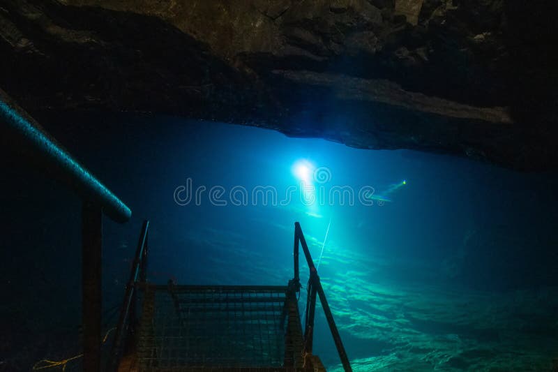 Cave Divers Training Deep Cave Dives in Old Coal Mine Lake. Light from ...
