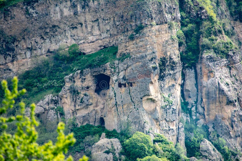 Cave in the Mountains. Steep Cliffs and a Cave with Trenches and Rooms ...