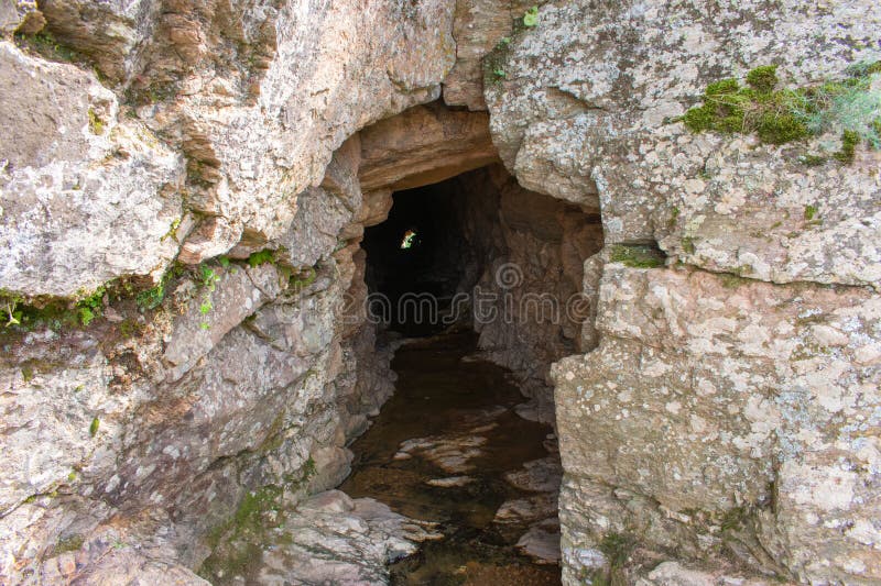 Cave in Rocky Mountain with River on the Floor Stock Image - Image of ...