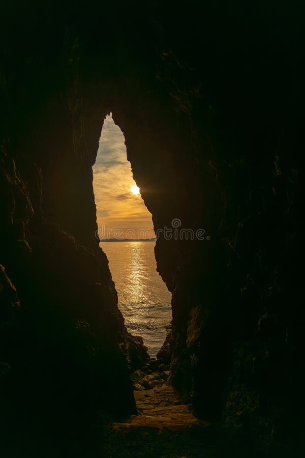 A Cave with a Small Opening in it and the Sun Shining through it. the ...