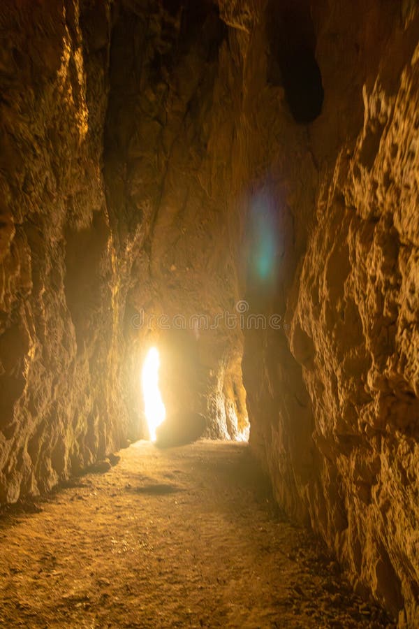 A Cave with a Small Opening in the Wall. the Light Shining through the ...