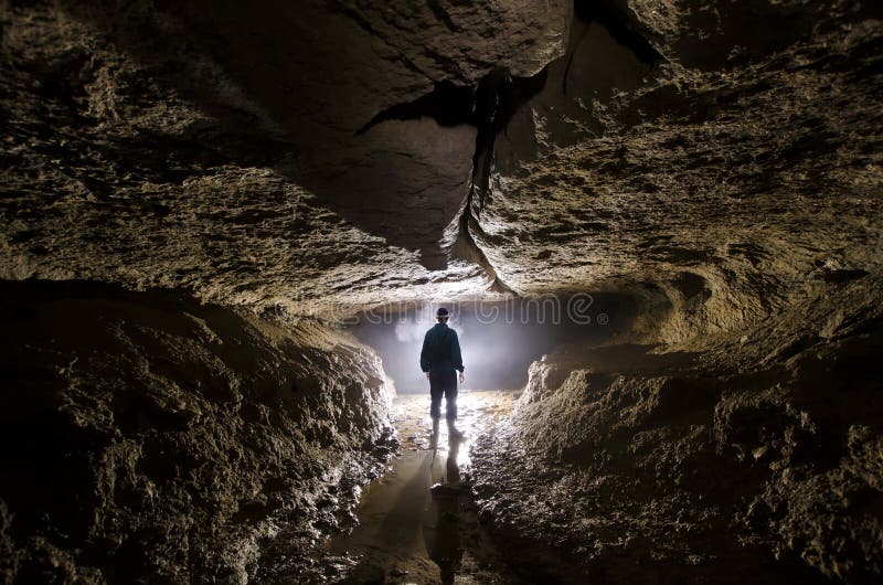 Cave Underground with Man Speleologist and Light at Entrance Stock ...