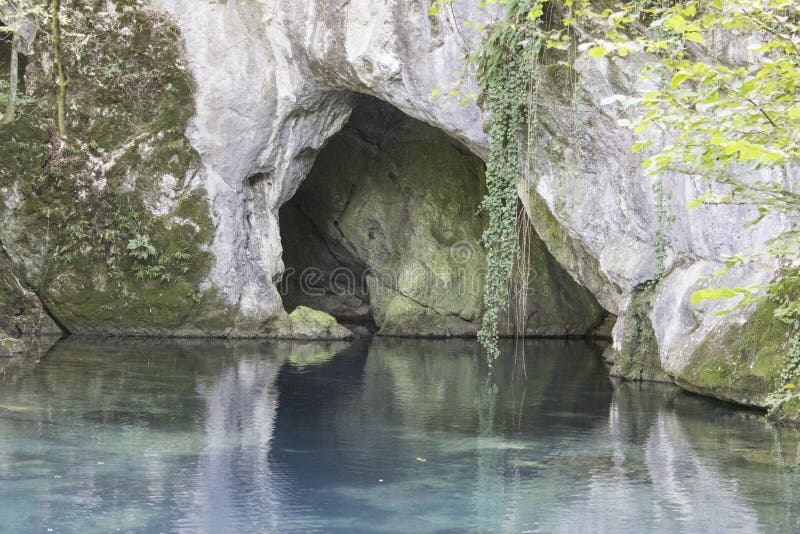 The Cave from Which the River Flows Stock Photo - Image of reflection ...