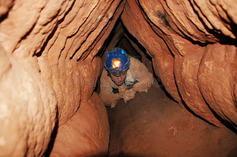 Narrow Cave Passage with a Cave Explorer Stock Image - Image of cave ...