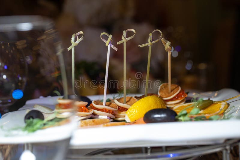 Caviar Canapes and Fish Slices on a Plate on the Buffet Table Stock ...