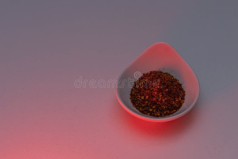 Cayenne Pepper Flakes in a Ceramic Container with Spicy Food Stock ...