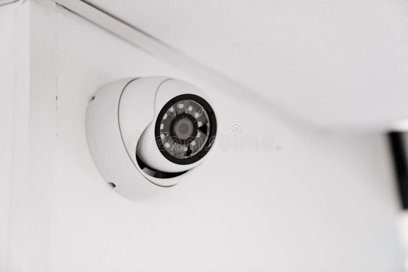 CCTV Camera with Broken Glass on a White Wall Under the Ceiling. Stock ...