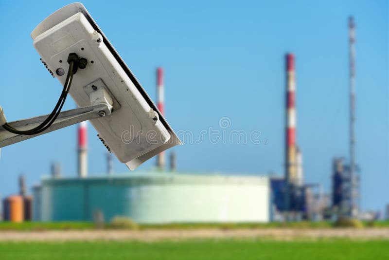 CCTV Camera Concept with Fuzzy Oil Storage Tanks on Background Stock ...