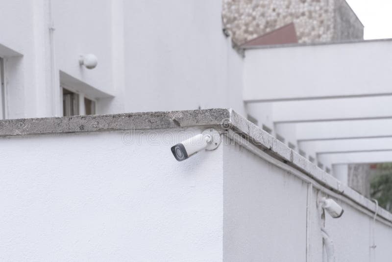 A CCTV Camera Hangs on the Corner of a Beige Building Stock Image ...