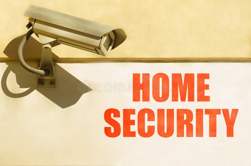 A CCTV Camera is Installed on the Wall of the Building, Next To it is ...