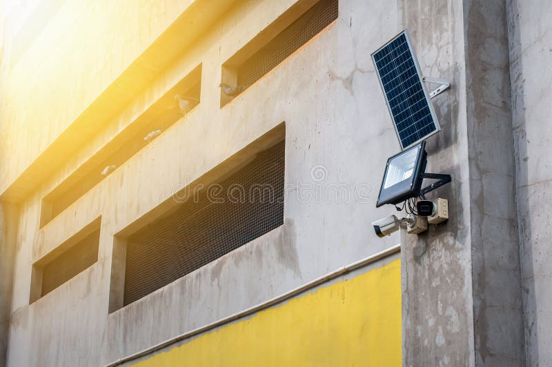 CCTV Camera with LED Spot Light and Solar Panel on Wall Stock Photo ...