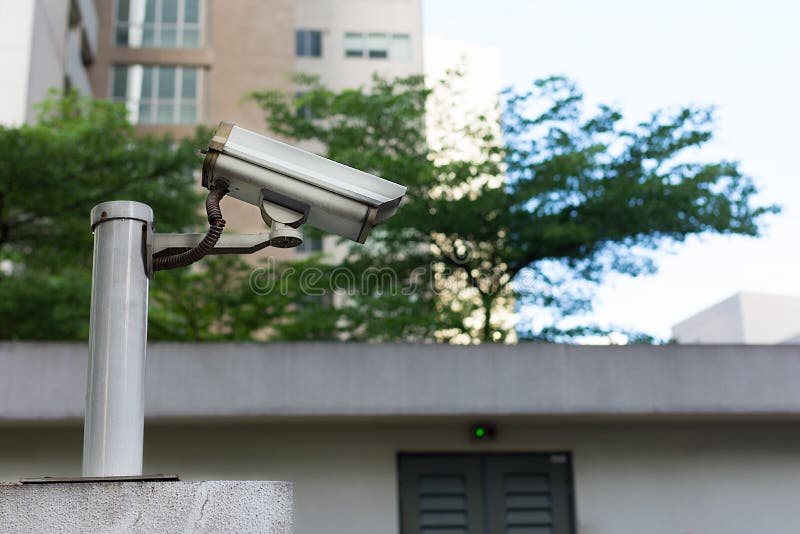 CCTV Camera Mounted on Top of a Wall Watching Over an Area. Stock Image ...