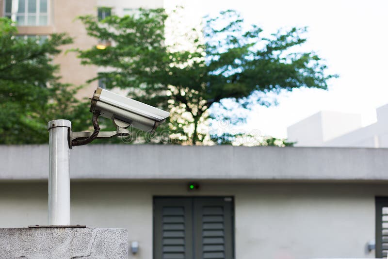 CCTV Camera Mounted on Top of a Wall Watching Over an Area. Stock Image ...