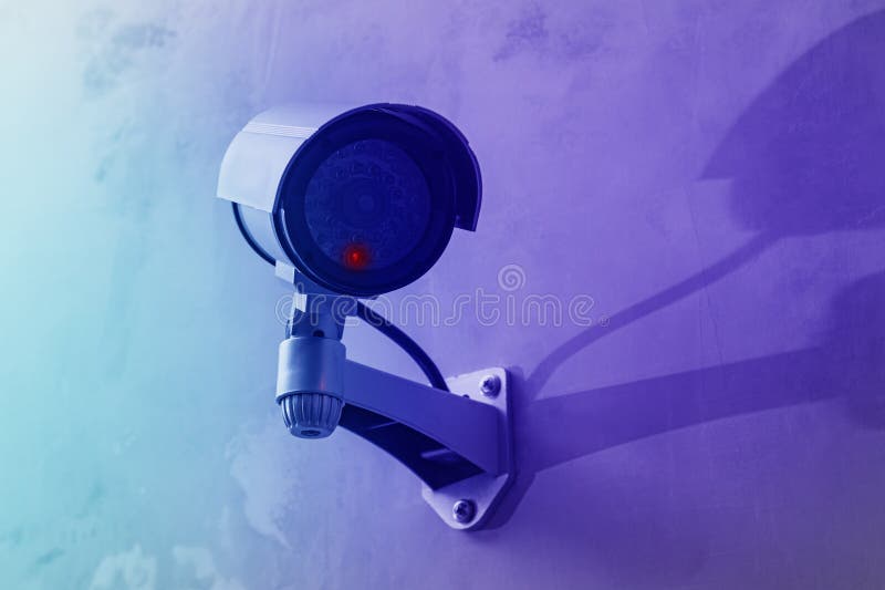 CCTV Security Camera with a Glowing Red Light is Mounted Against a ...