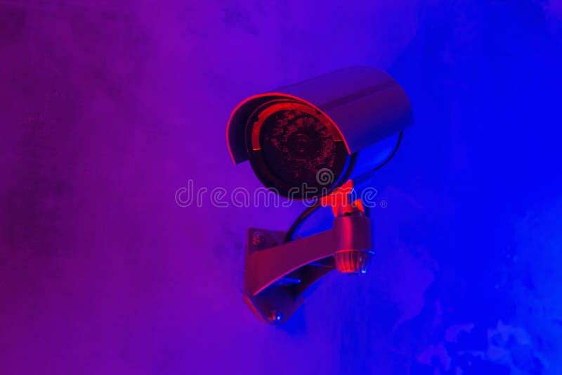 CCTV Security Camera with a Glowing Red Light is Mounted Against a ...