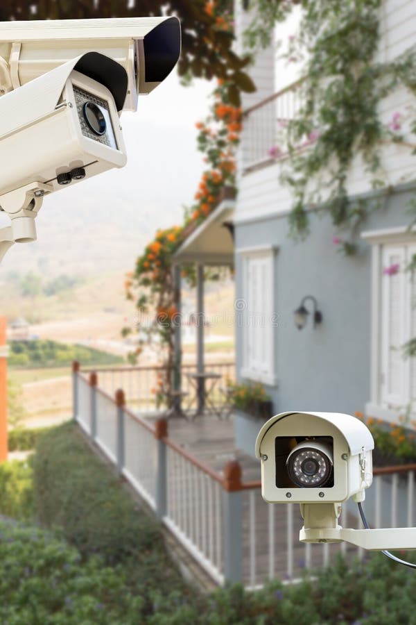 CCTV Security Camera Operating on Backyard Roofing House. Stock Image ...