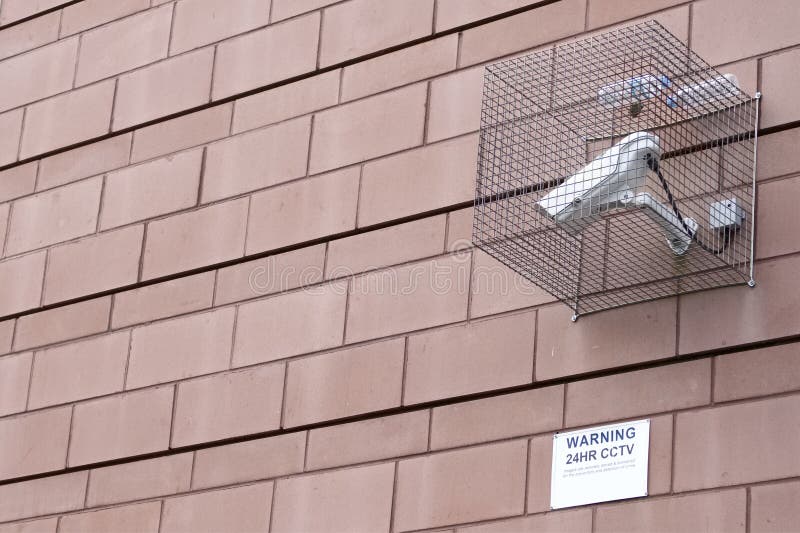 CCTV Security Camera in Operation in Cage Fixed To Wall of Workplace ... CCTV Security Camera in Operation in Cage Fixed To Wall of Workplace ...
