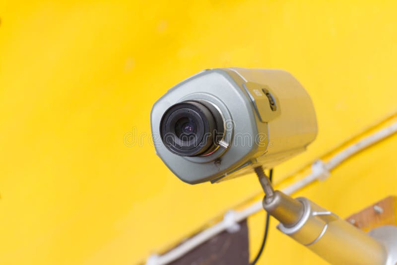 CCTV on a yellow wall stock image. Image of privacy, private - 56565029