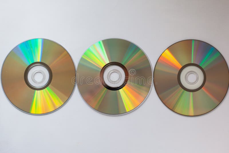 3 Cd Compact Disks with Computer Drivers in a Row on a White Background ...