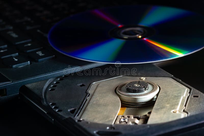 CD on the Computer Notebook Cd Rom in Darkness. Stock Image - Image of ...