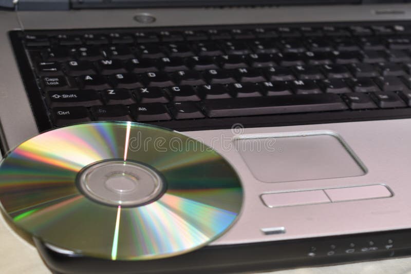 CD disk on a computer stock photo. Image of technology - 117388996