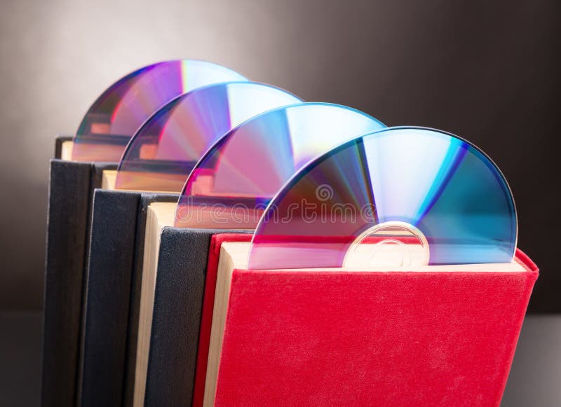 Cd Disks are Sticks Out from Red Book Stock Photo - Image of learning ...