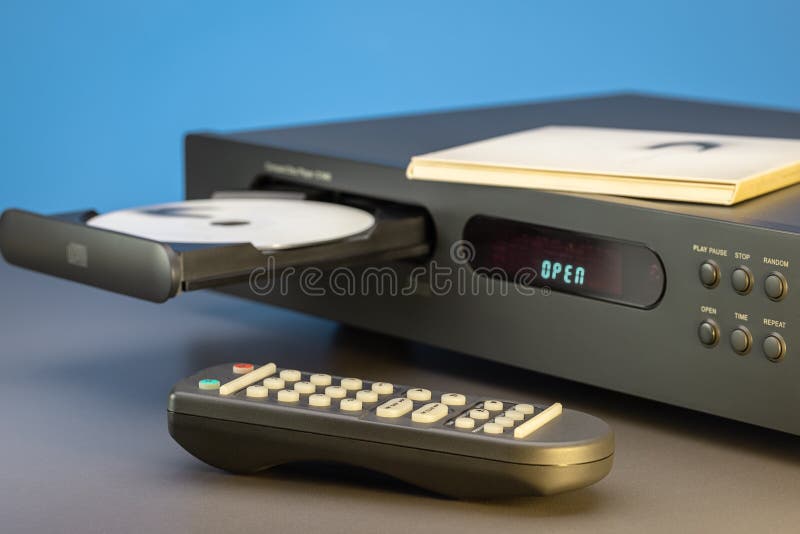CD Player, Open Disc Tray, Remote Control on the Table. Close-up, Blue ...