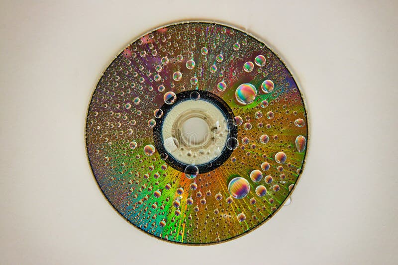 CD on White Background with Rainbow Water Drops on Reflective Metal ...