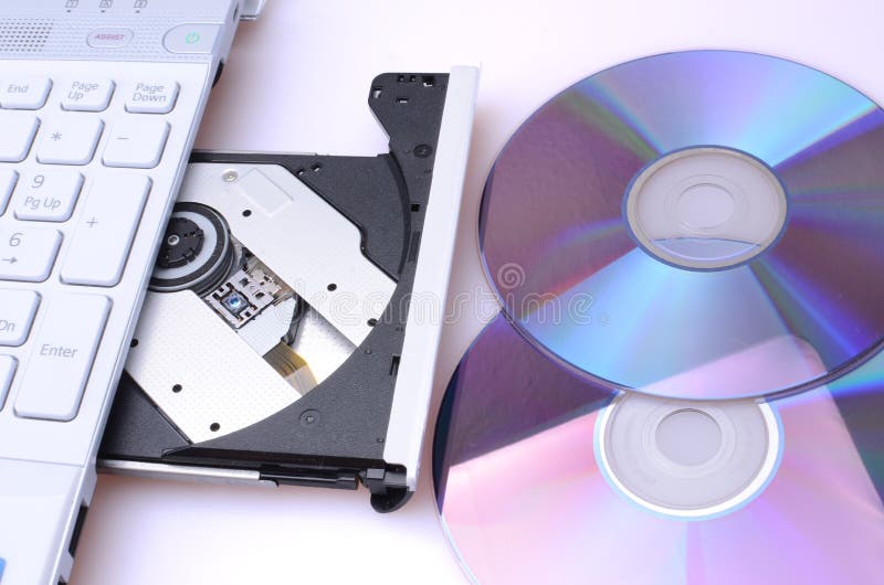 CDs with laptop disk drive stock photo. Image of disk - 22616374