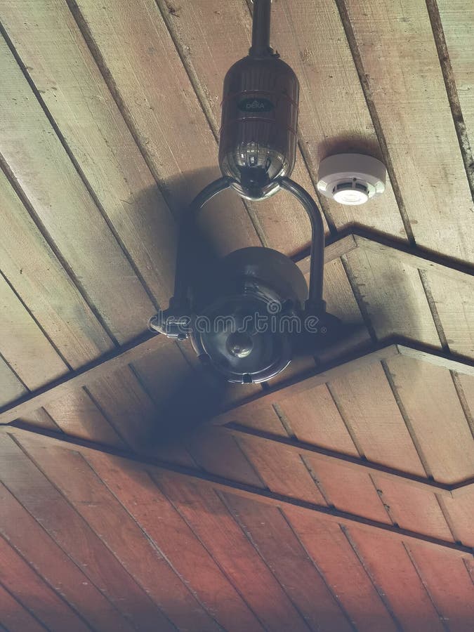 A Ceiling Fan and Smoke Detector are Positioned on a Wooden Ceiling ...