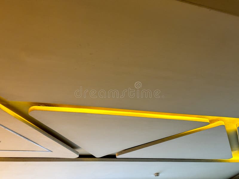 A Ceiling with a Yellow Light Shining on it Stock Photo - Image of ...