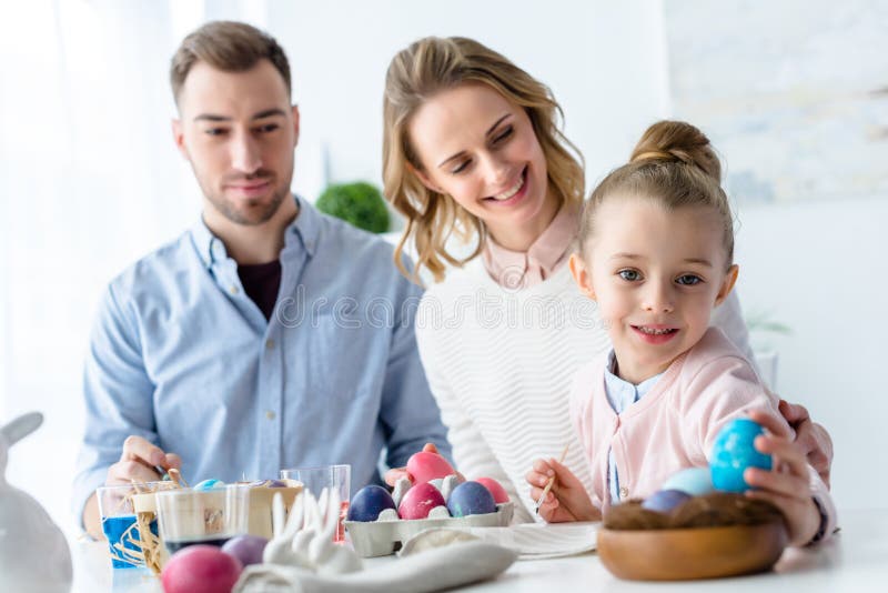 Celebrating Family Arranging Painted Eggs in Nest Stock Photo - Image ...