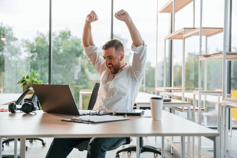 Celebrating Success. Happy Man in Formal Clothes is Working in the ...