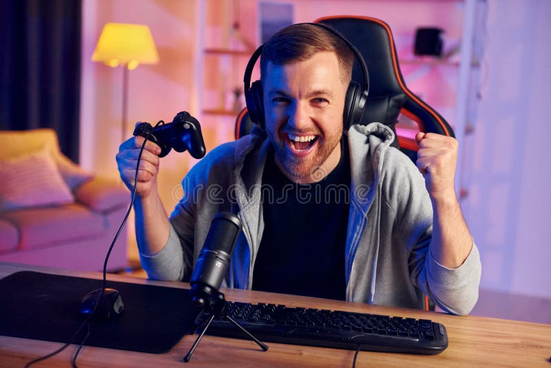 Celebrating Victory. Man in Headphones and with Microphone is Live on ...