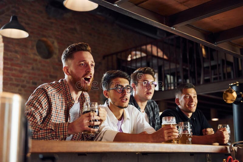 Celebrating Victory. People in Casual Clothes Sitting in the Pub Stock ...