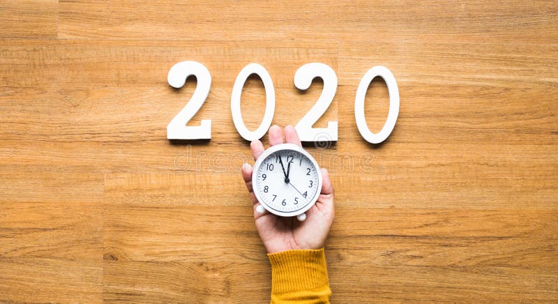 2020 Celebration Countdown with Hand Holding Alarm Clock and Mock Up ...