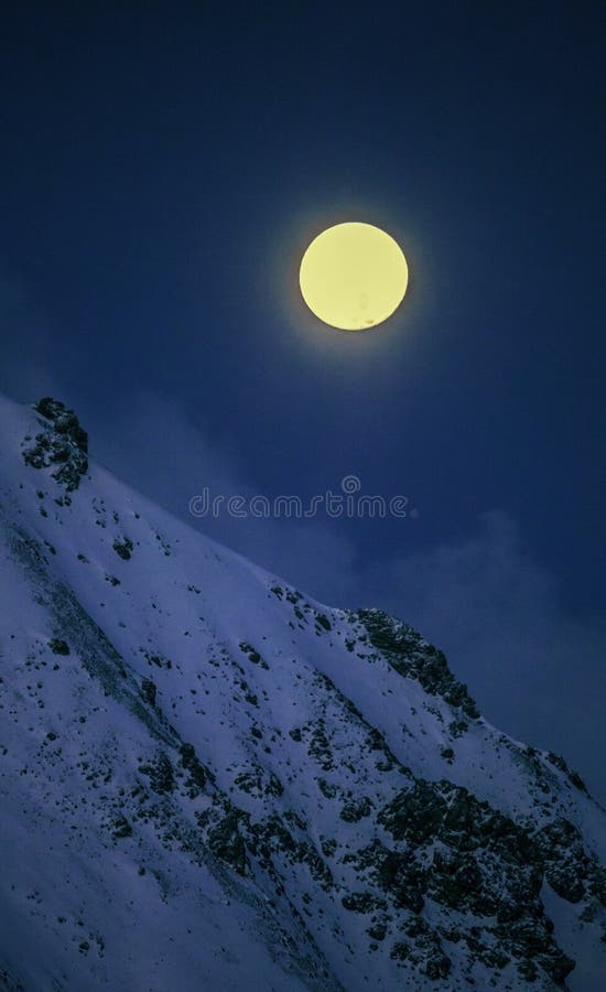Celestial Landscape with Bright Full Disc-shaped Moon Above Rocky ...