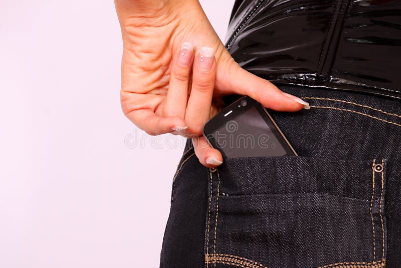 Cell phone in back pocket stock image. Image of hands - 14588765