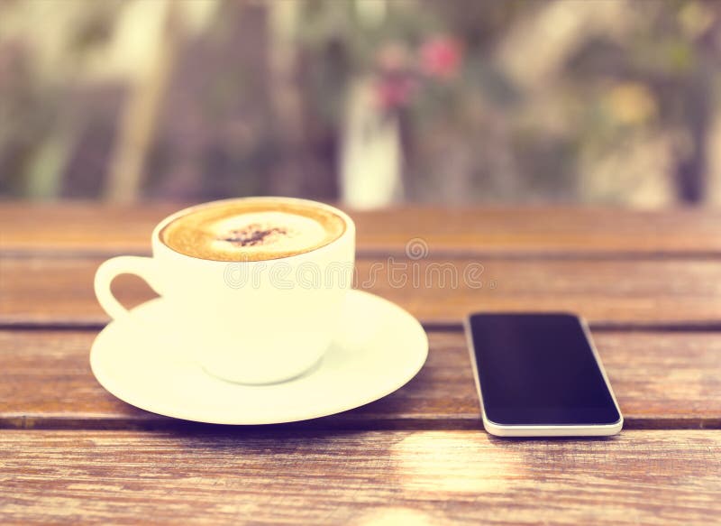 Cell Phone and Cup of Coffee on a Wooden Table Stock Photo - Image of ...