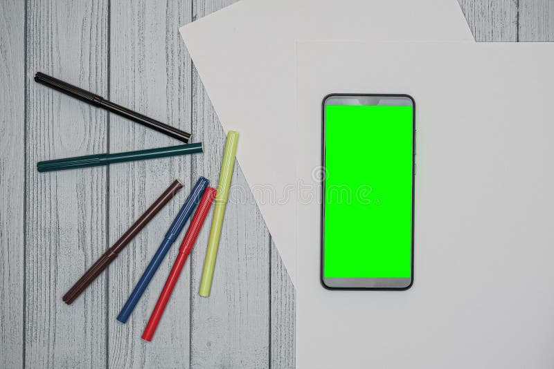 Cell Phone with Green Screen with Felt-tip Pens and White Sheets on a ...
