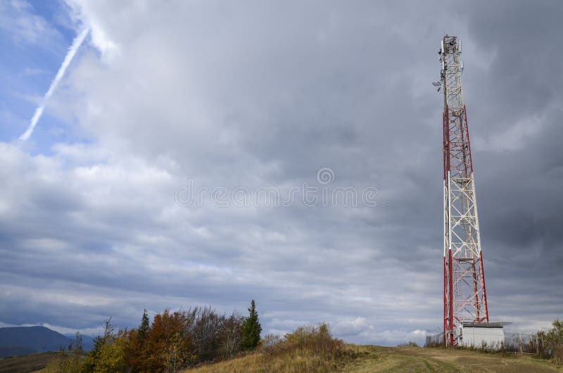 Cell Phone Tower on Top of a Hill with Mountains on Background Stock ...