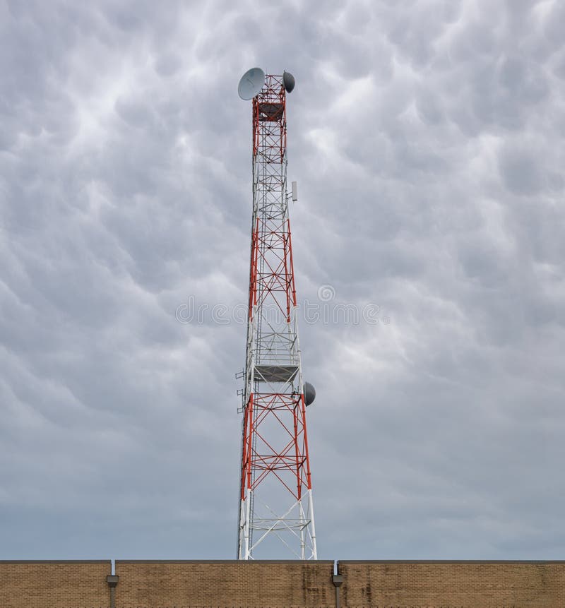 Cell Phone Tower Viewed Over a Brick Building Stock Photo - Image of ...