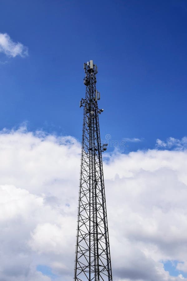 Cell Tower Against Blue Sky with Clouds. a Cell Site or Tower with ...