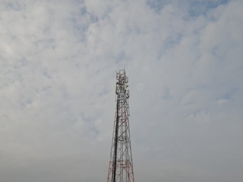 Two Cell Towers Rise Above Some Lush Green Hills and Trees Stock Image ...