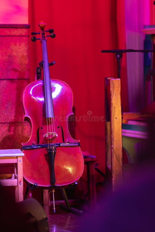 A Cello Stands on an Illuminated Stage in a Local Bar Stock Photo ...