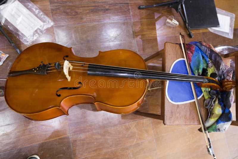 Cello supported in chair stock image. Image of cello - 237948749